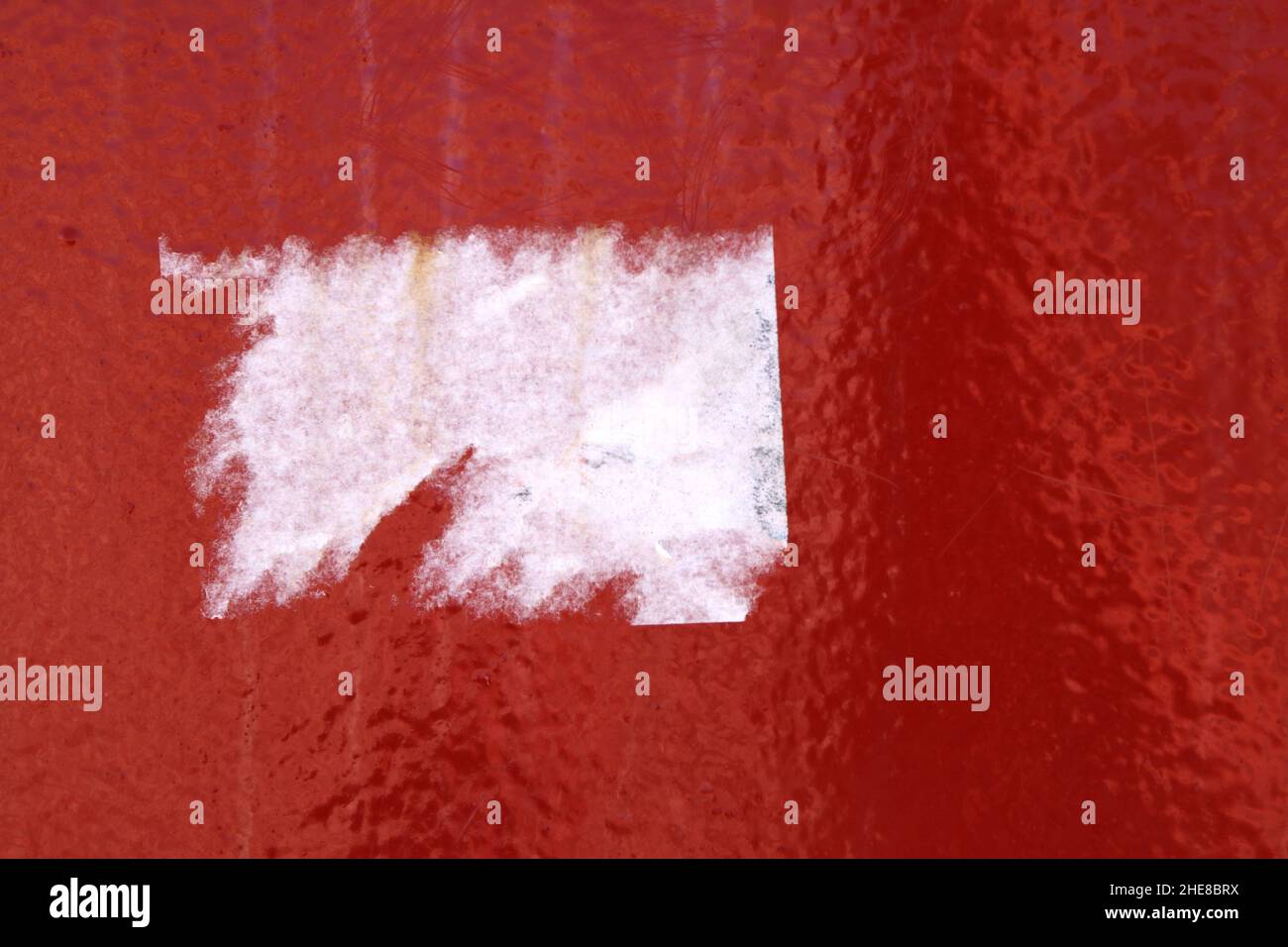 White Snippet Of Paper Torn Off From Red Background Stock Photo - Alamy