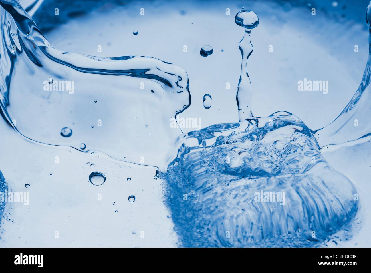 Ice Cube Falling Into Water Stock Photo - Alamy