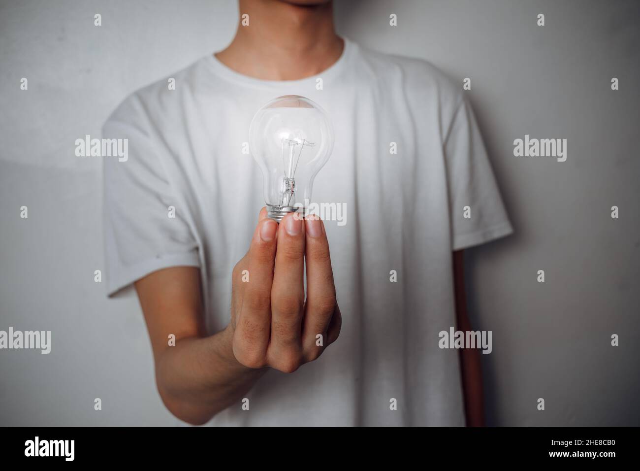 Caucasian hands holding light bulb, business idea concept Stock Photo ...