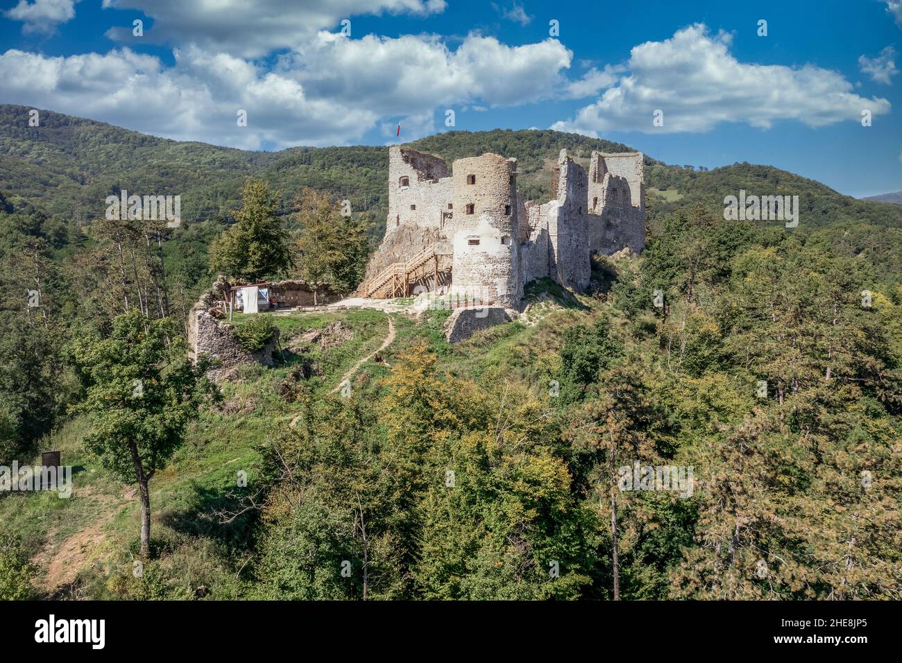 Aerial view of under restoration medieval Reviste castle above the Hron (Garam) river in ...