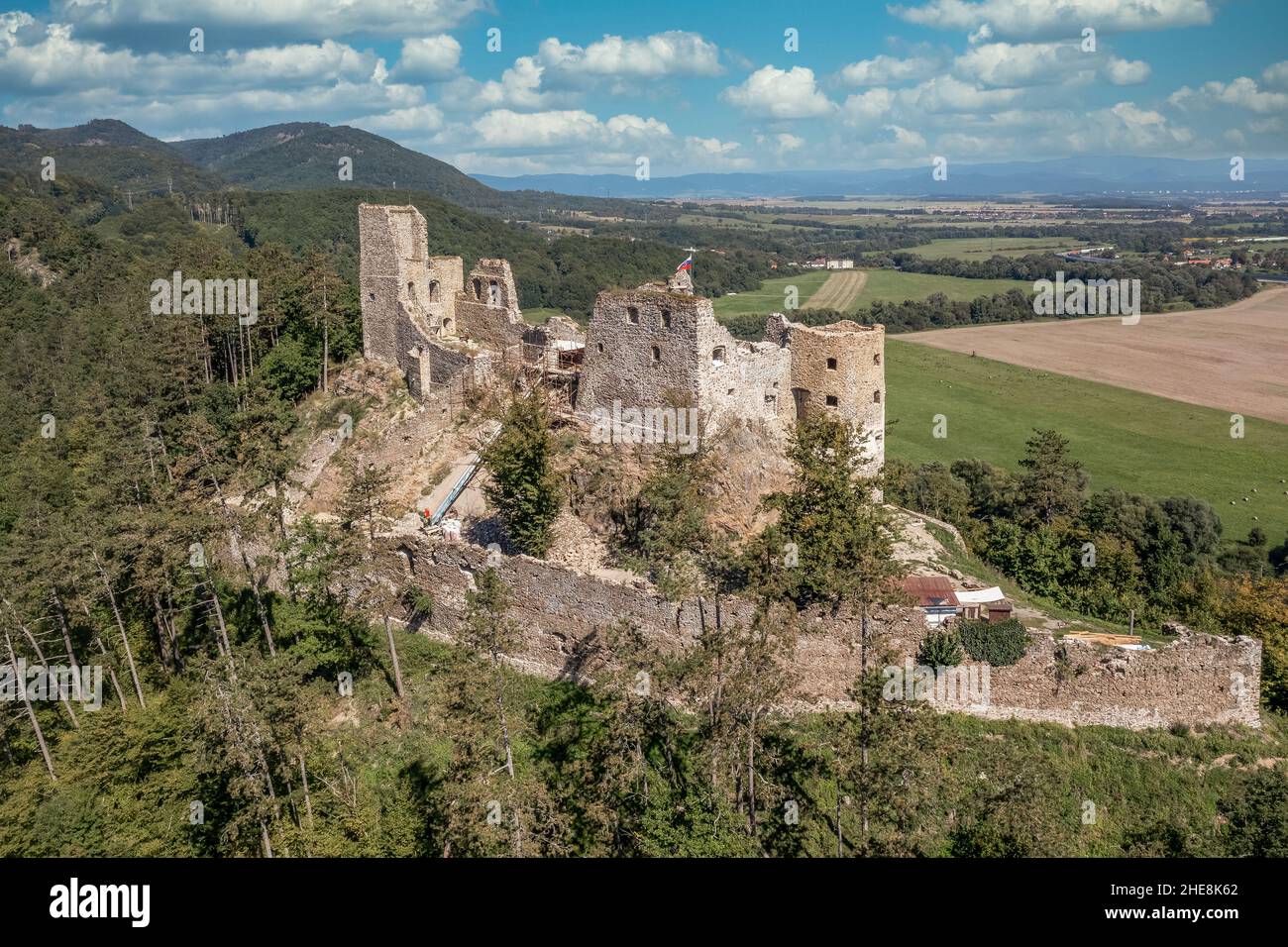 Aerial view of under restoration medieval Reviste castle above the Hron (Garam) river in ...
