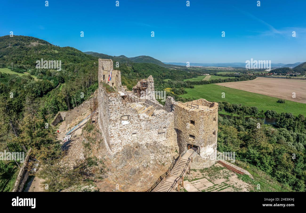 Aerial view of under restoration medieval Reviste castle above the Hron (Garam) river in ...