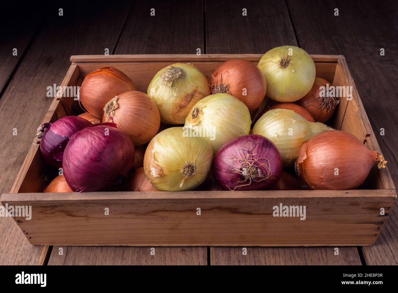 Onions in old box on rustic wooden table, food ingredients Stock Photo ...