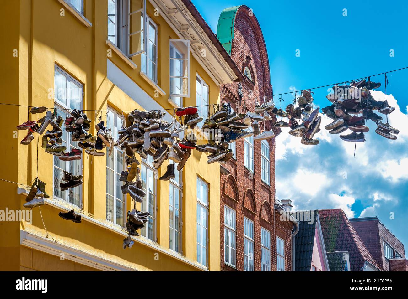 Suspended Shoes On A Leash Across The Street Stock Photo - Alamy