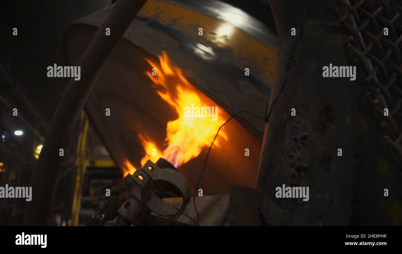 Close up of firing process in the hot shop of the factory. Industrial ...