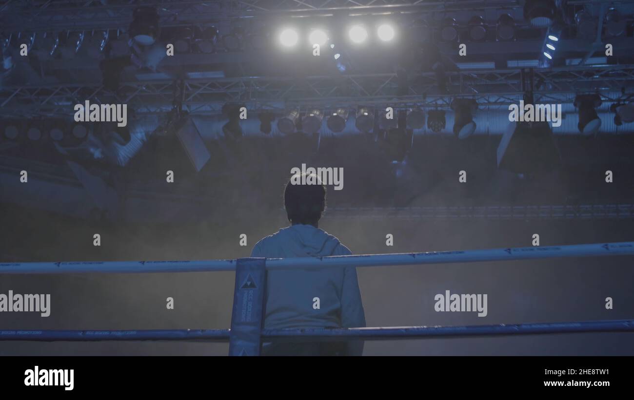 Back view of working gaffer or lighting technician and spotlights ...