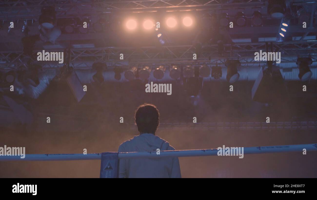 Back view of working gaffer or lighting technician and spotlights ...