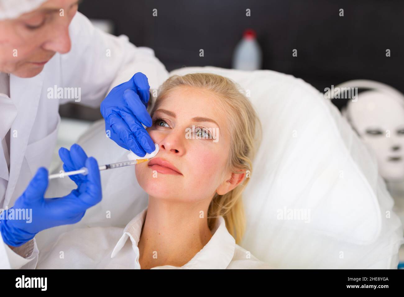Woman getting filler injections for facial skin tightening at ...