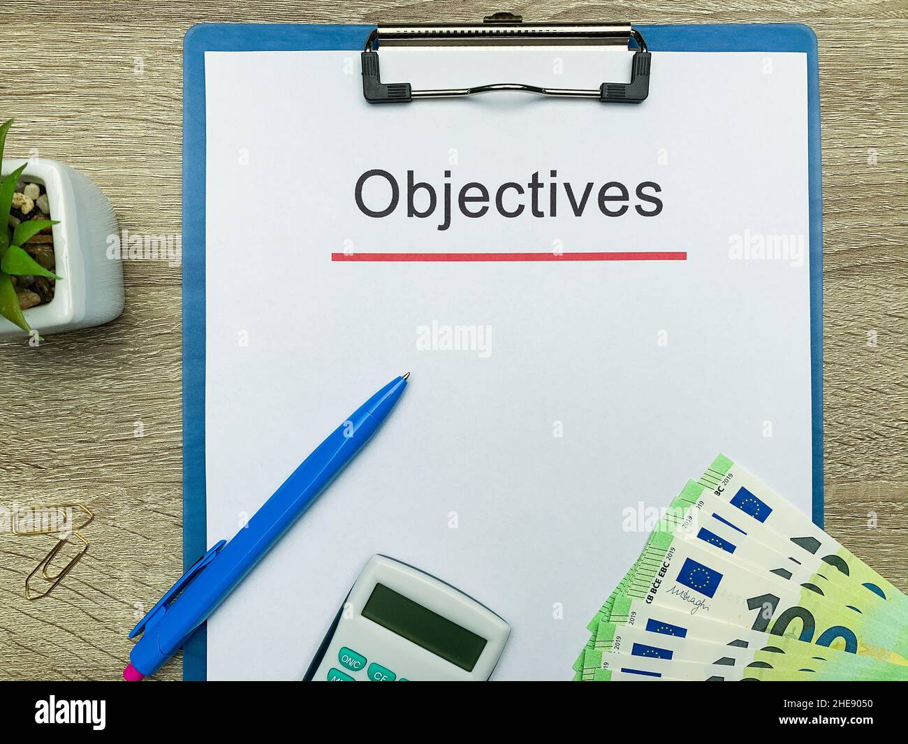 Paper with text objective on wood table Stock Photo - Alamy