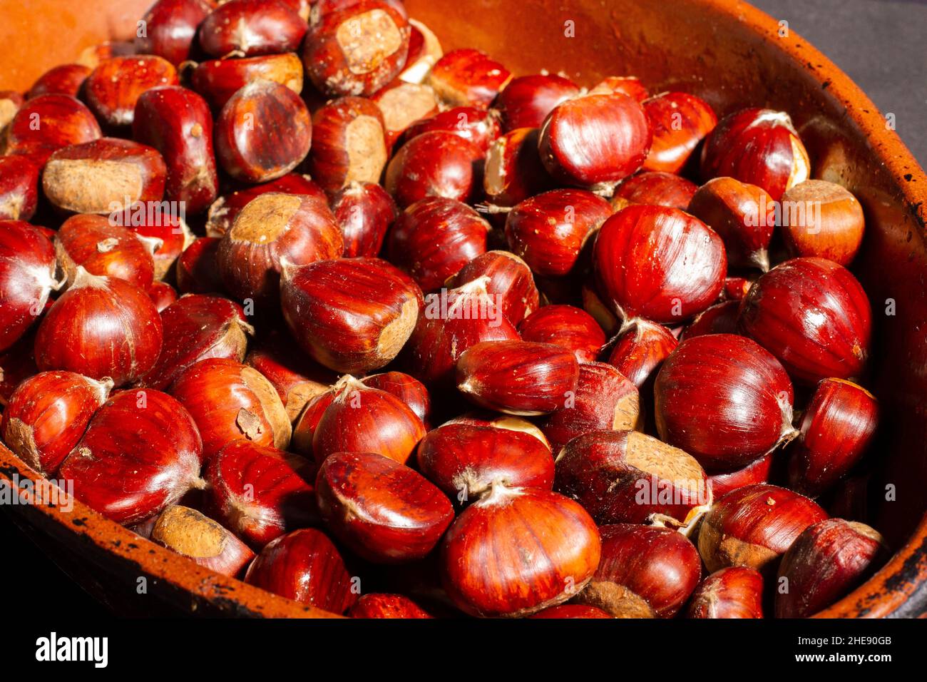 natural chestnuts in clay fountain on gray background Stock Photo - Alamy