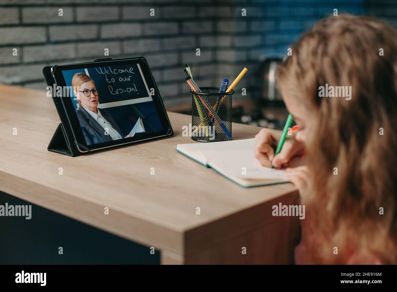 Little girl taking Internet web lesson while doing the exercice. Child ...