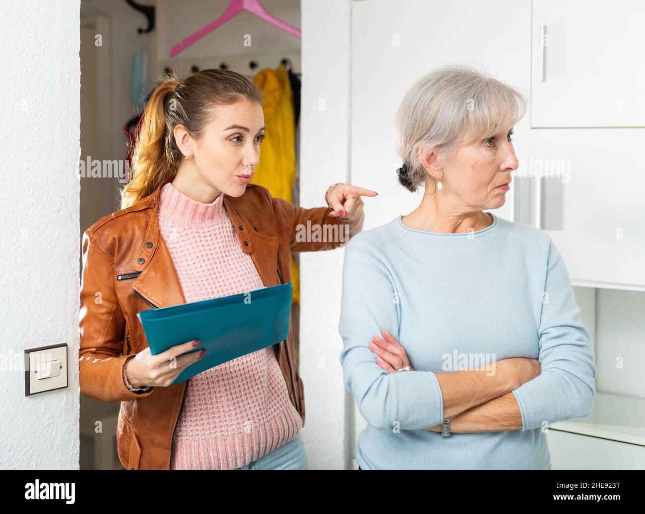 Angry female householder demanding older woman to pay off debt Stock ...