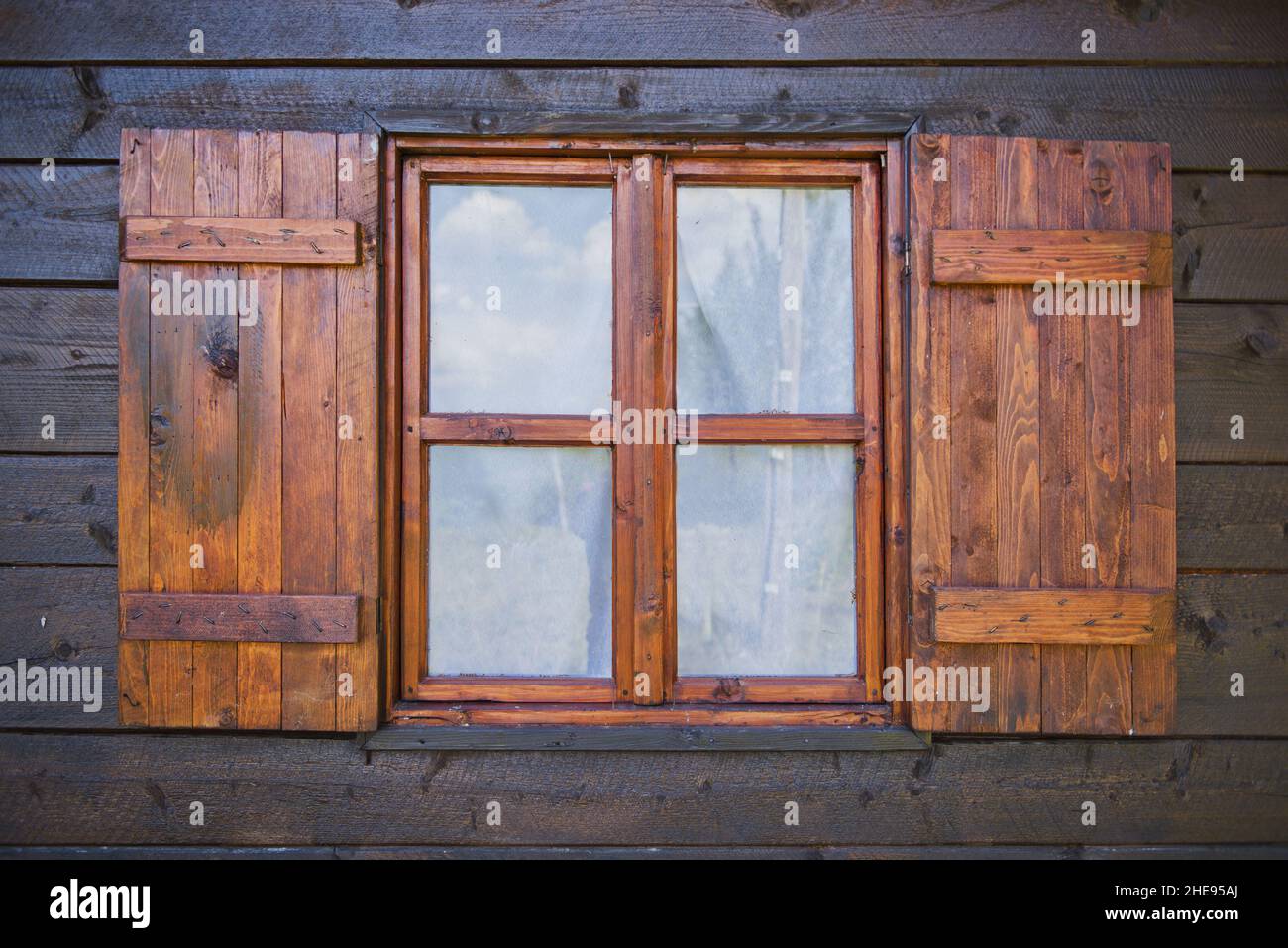 Closed wooden window with wind shutters in brown timbered house Stock ...