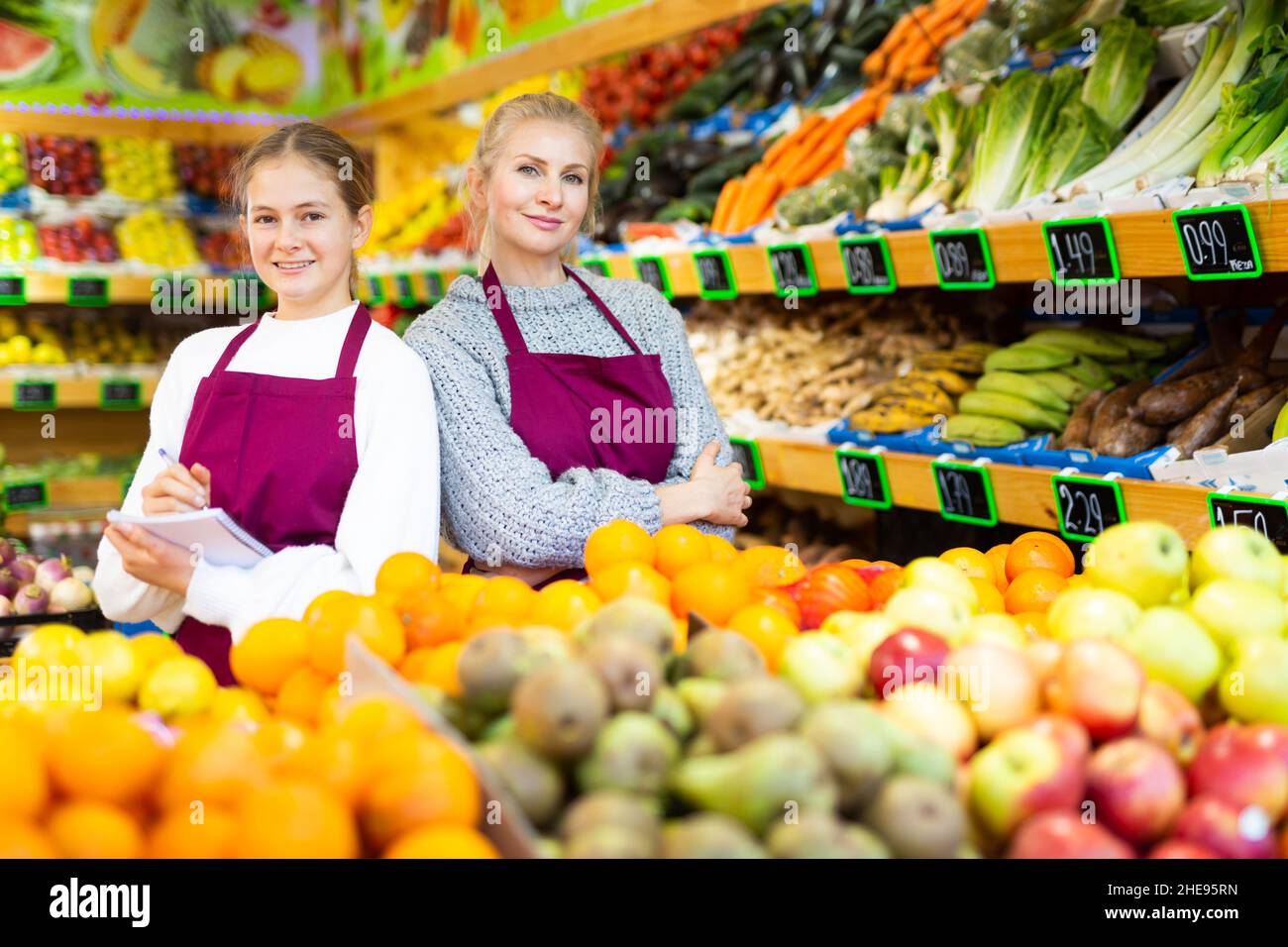 Girl helping her mother work as a salesman in a grocery store Stock ...