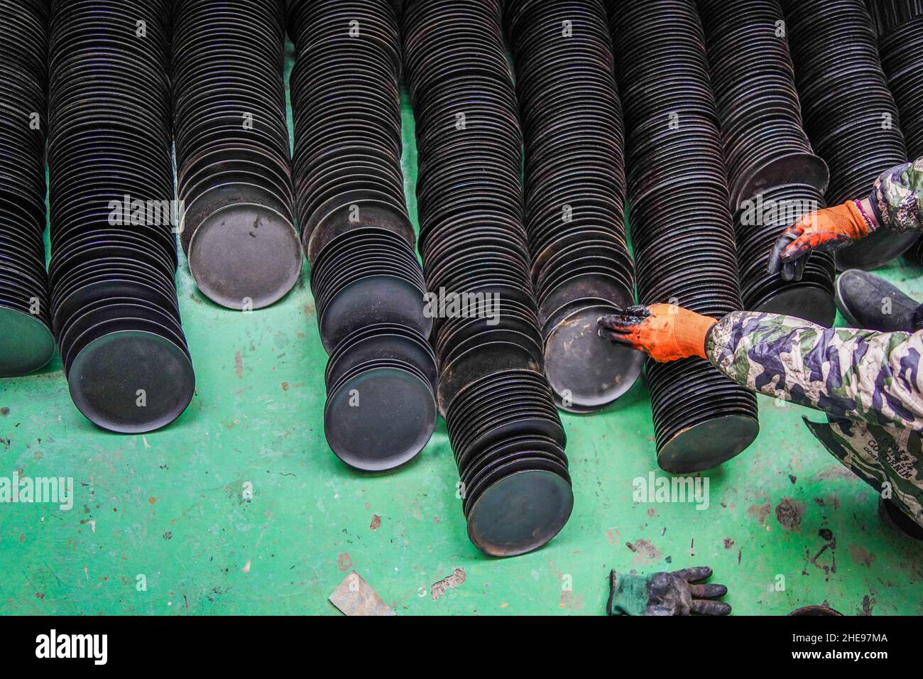 BIJIE, CHINA - JANUARY 3, 2022 - Workers polish lacquerware products at ...