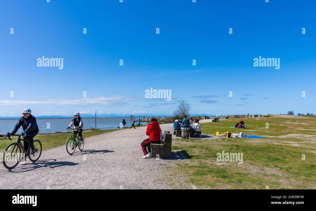 People doing cycling and having a picnic in the Garry Point Park in ...