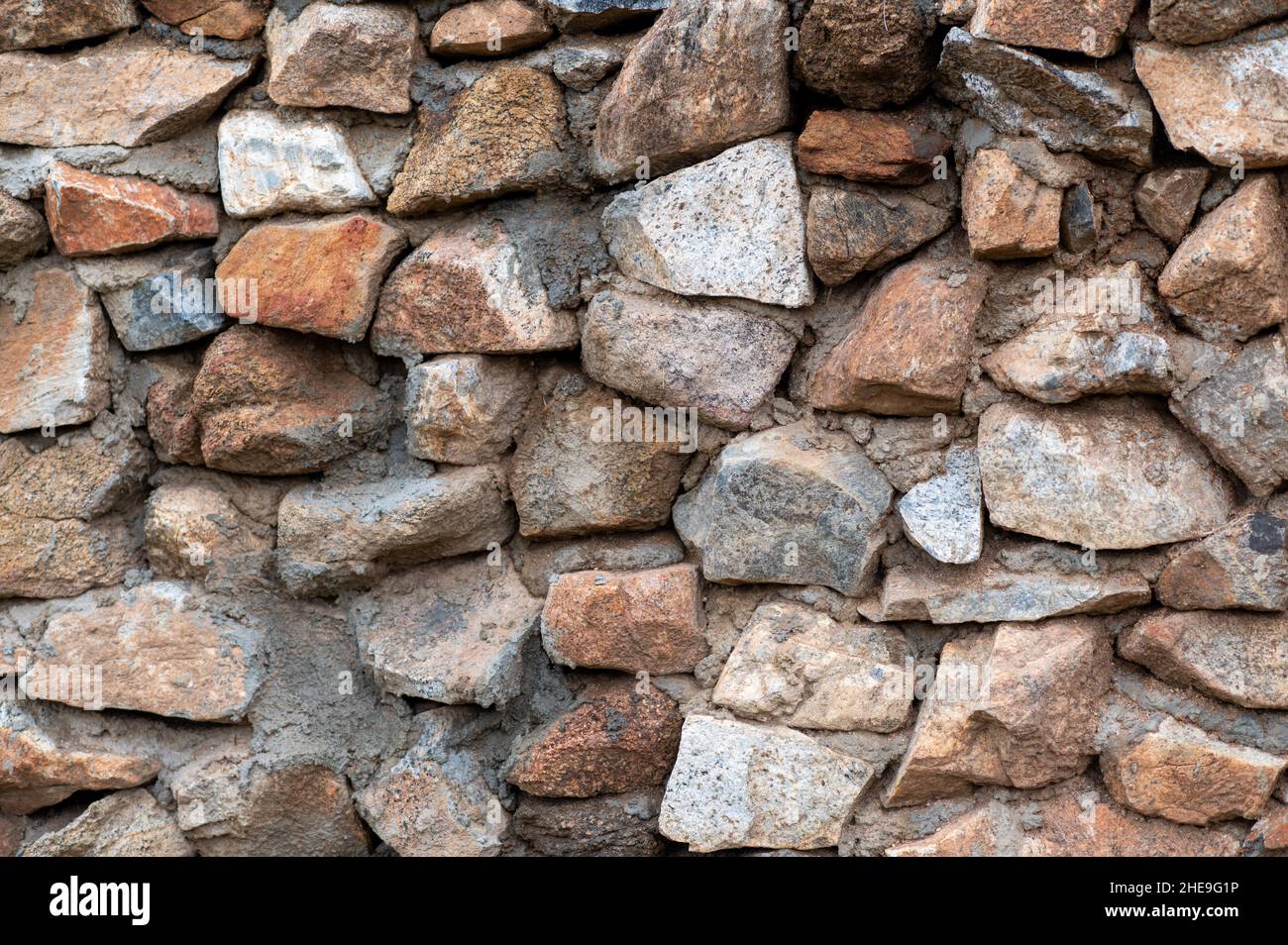 Wall made of stones and rocks Stock Photo - Alamy