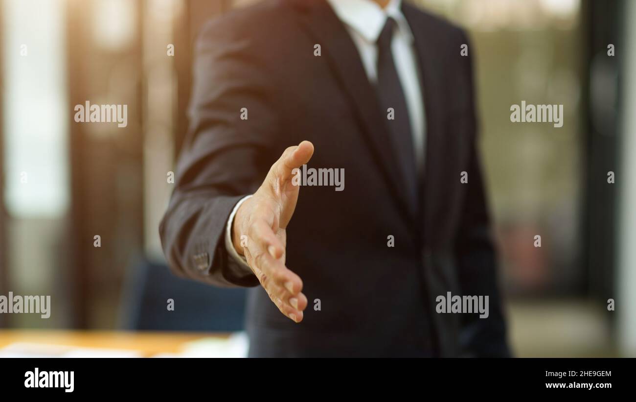 A business man in formal suit posting a greeting hand or shaking hand ...