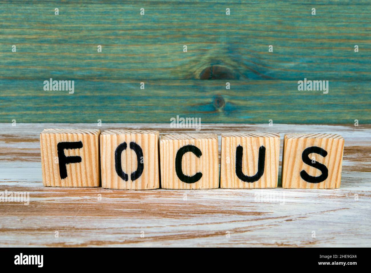 Focus. Word from wooden letters on a white and green background Stock ...