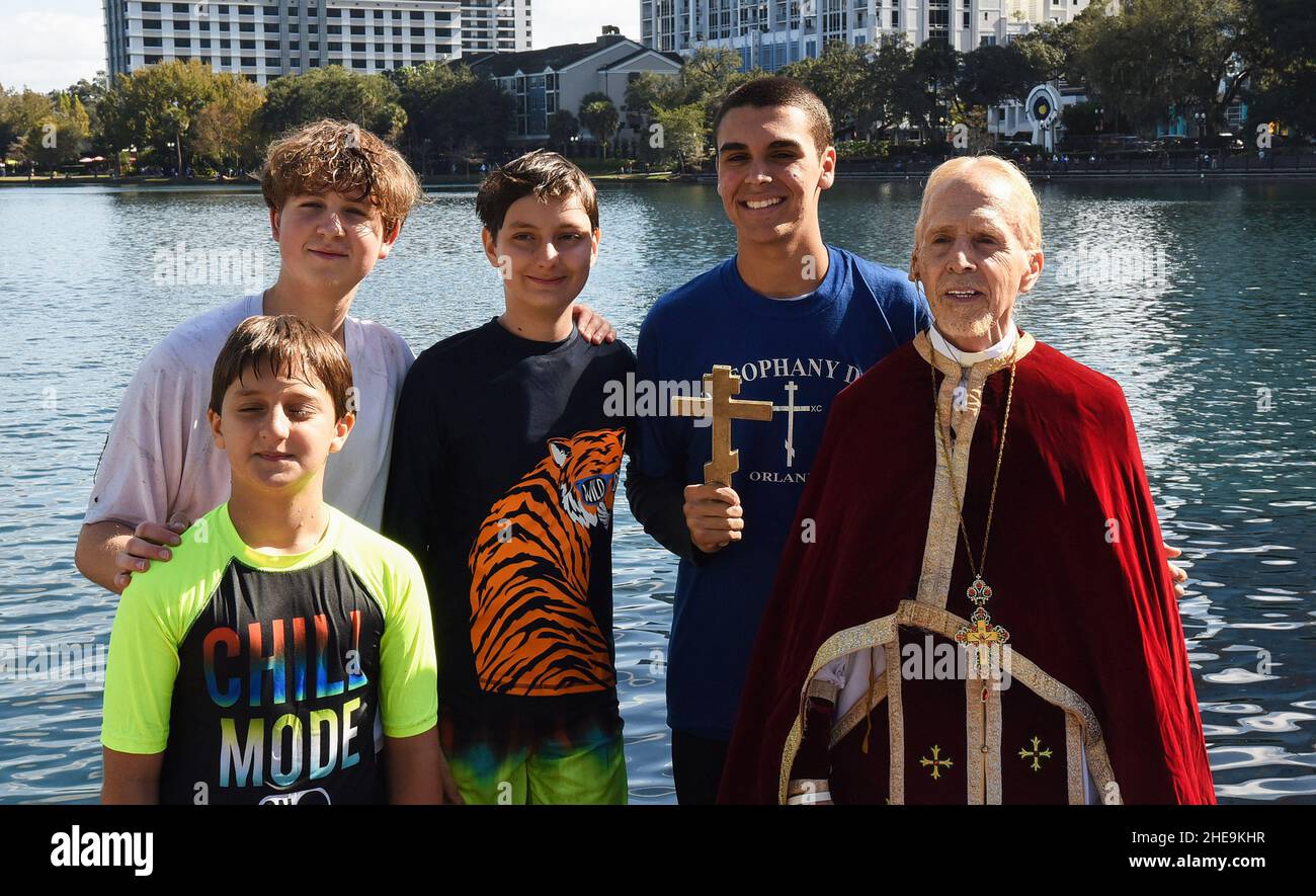 Isaac Abdelmessih (holding cross) poses with Fr. John Hamatie (R) and ...