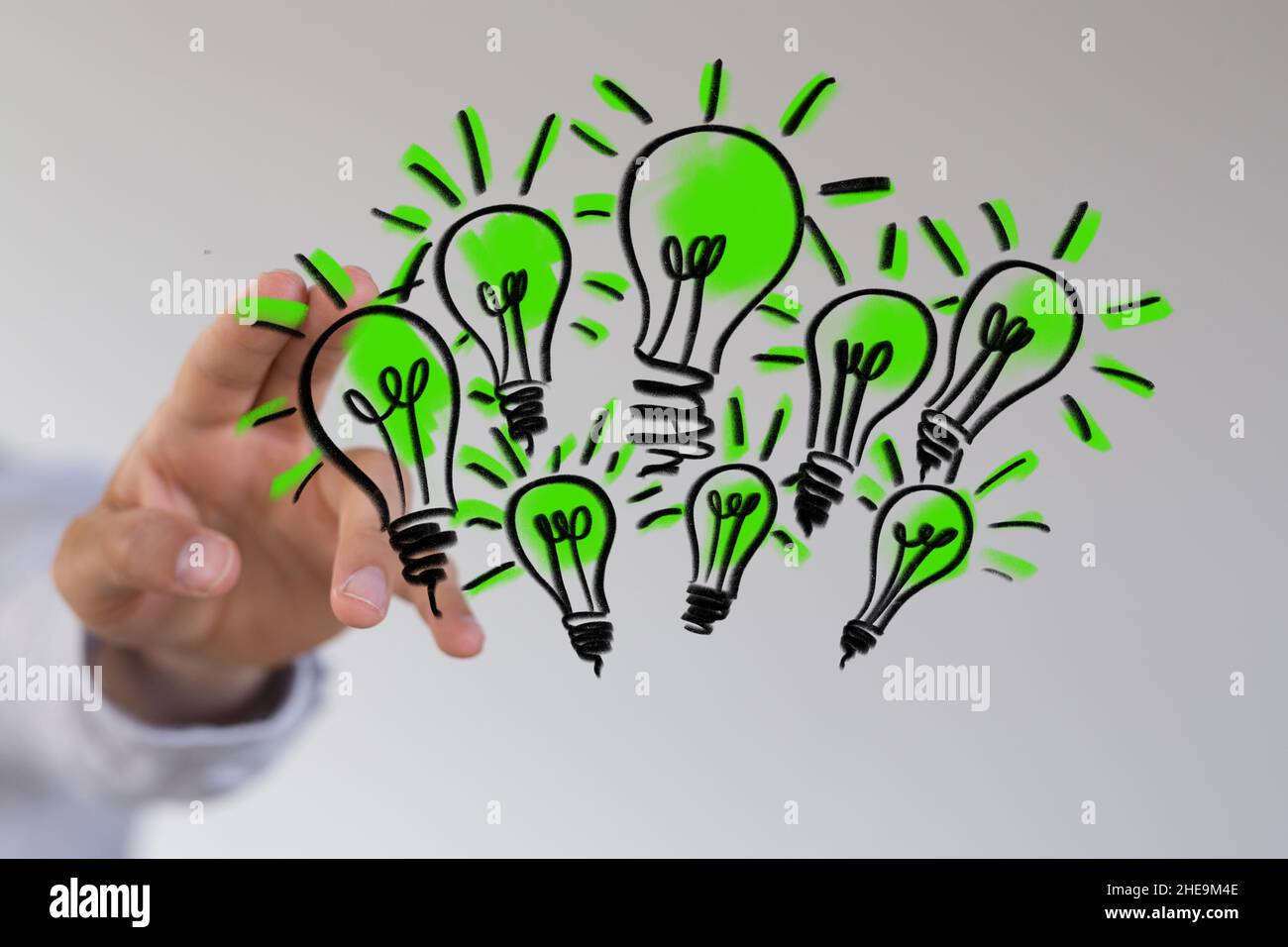 Shallow focus of a human hand pointing on green light bulbs, creative ...