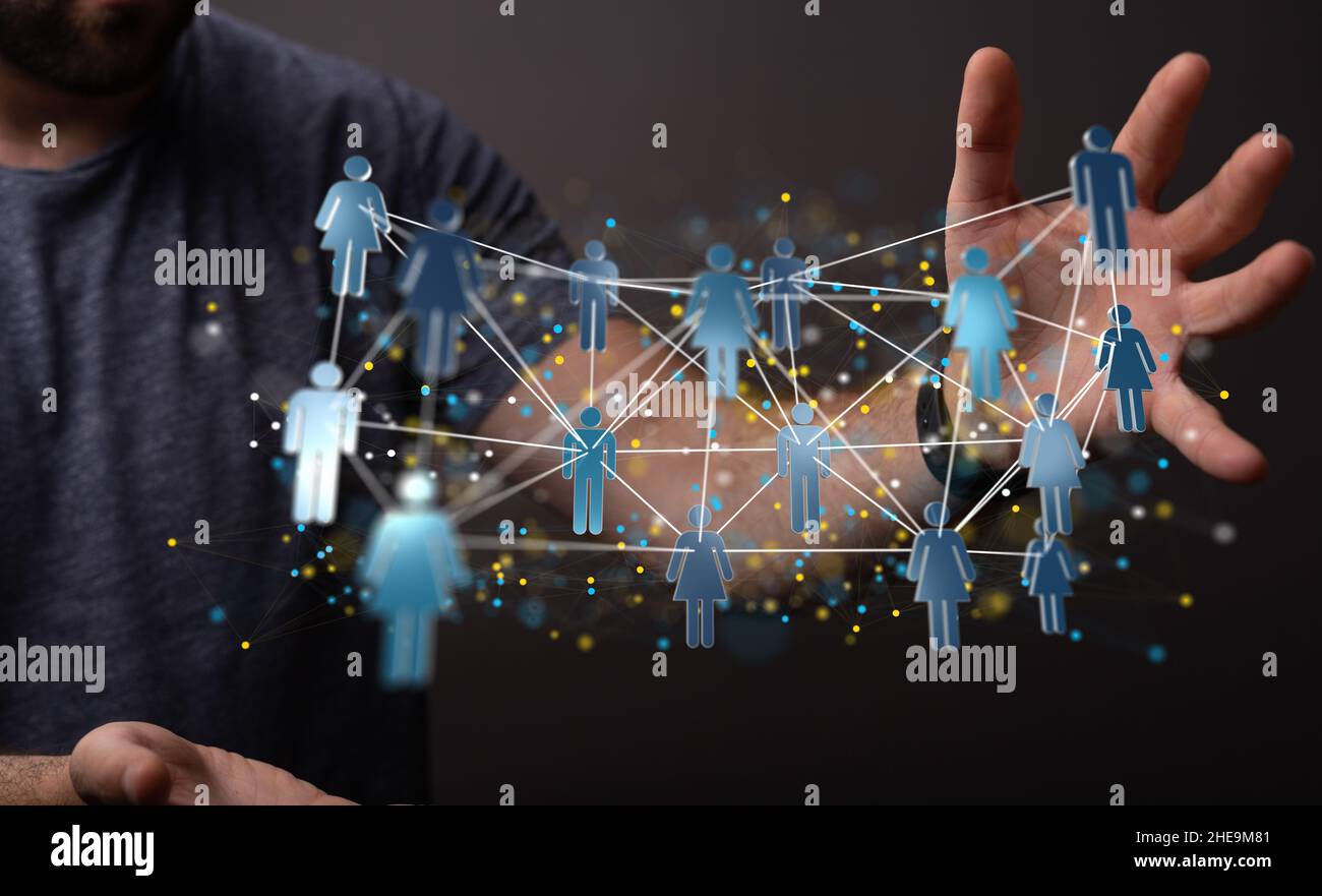 Shallow focus of human hands holding interconnected human icons, team ...