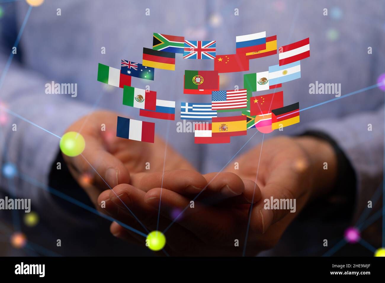 Shallow focus of human hands holding the flags of various countries ...