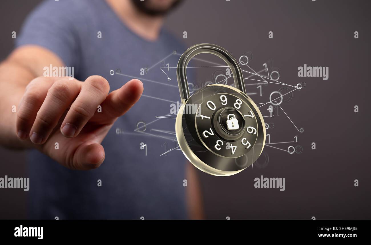 Shallow focus of a human hand pointing on a safe lock icon ...