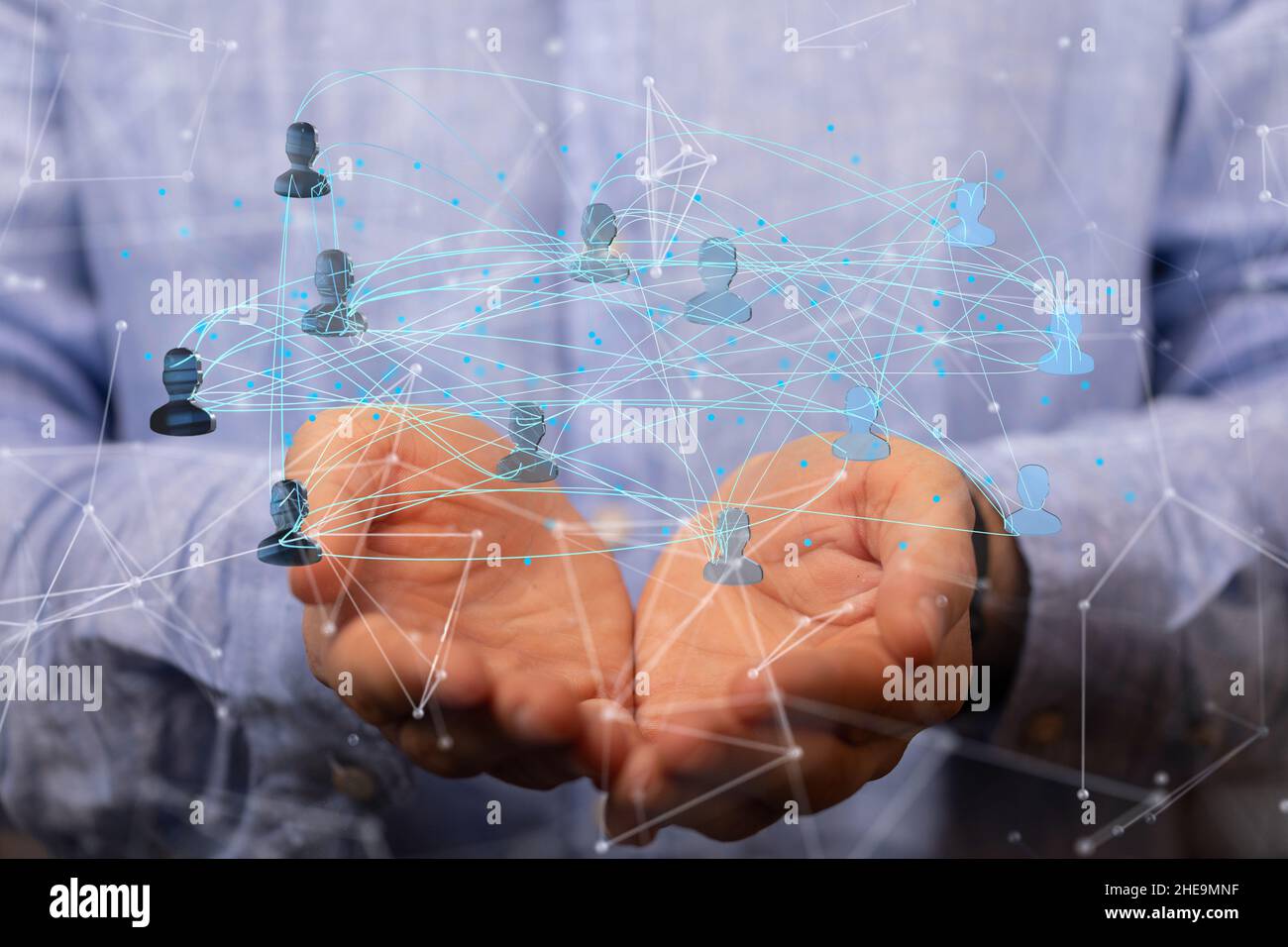 Shallow focus of human hands holding interconnected human icons for ...