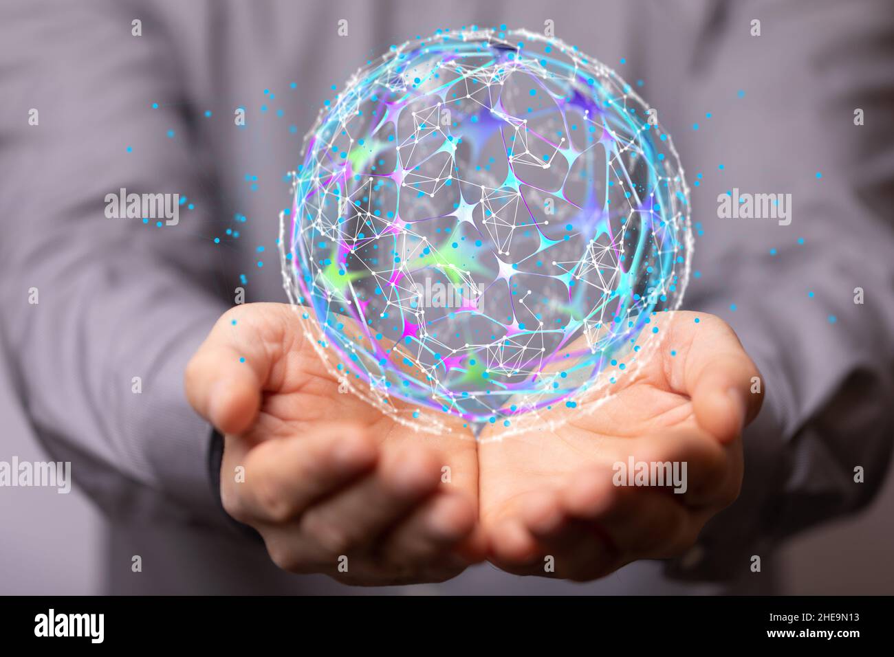 Shallow focus of human hands holding an interconnected globe icon ...