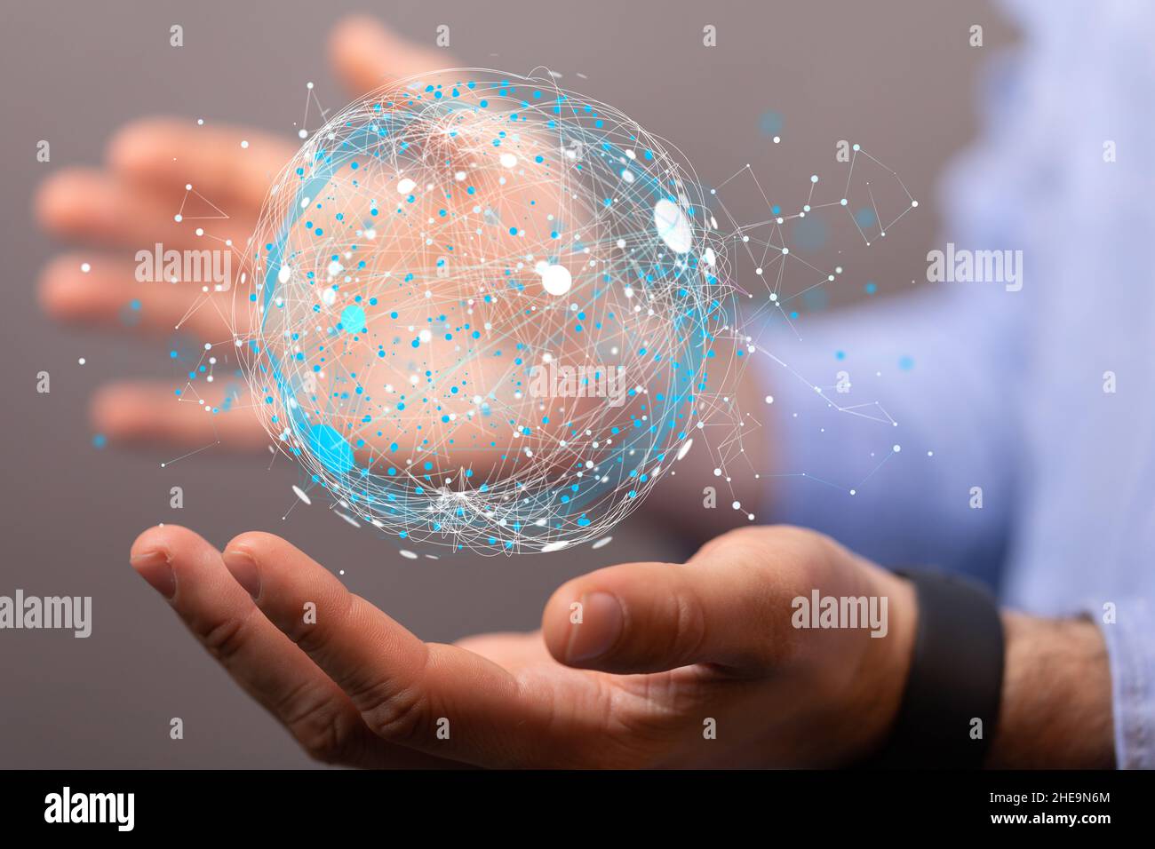 Shallow focus of human hands holding an interconnected globe icon ...