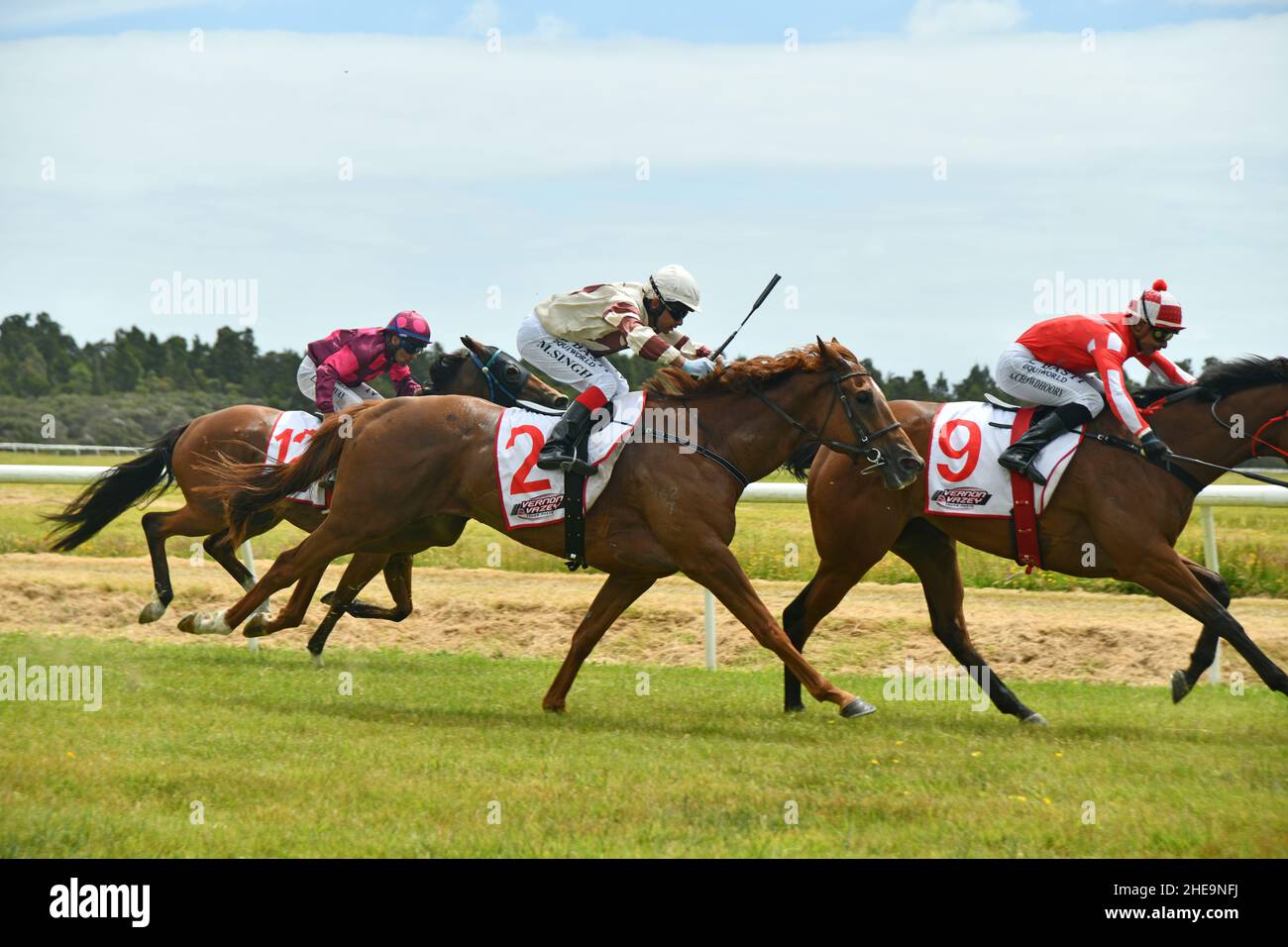 KUMARA, NEW ZEALAND, JANUARY 8, 2022; jockeys ride their mounts hard to the finish line in a ...