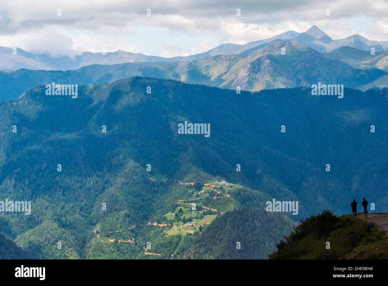 Tourists watch village in the Himalayas from Chelela Pass, the highest ...