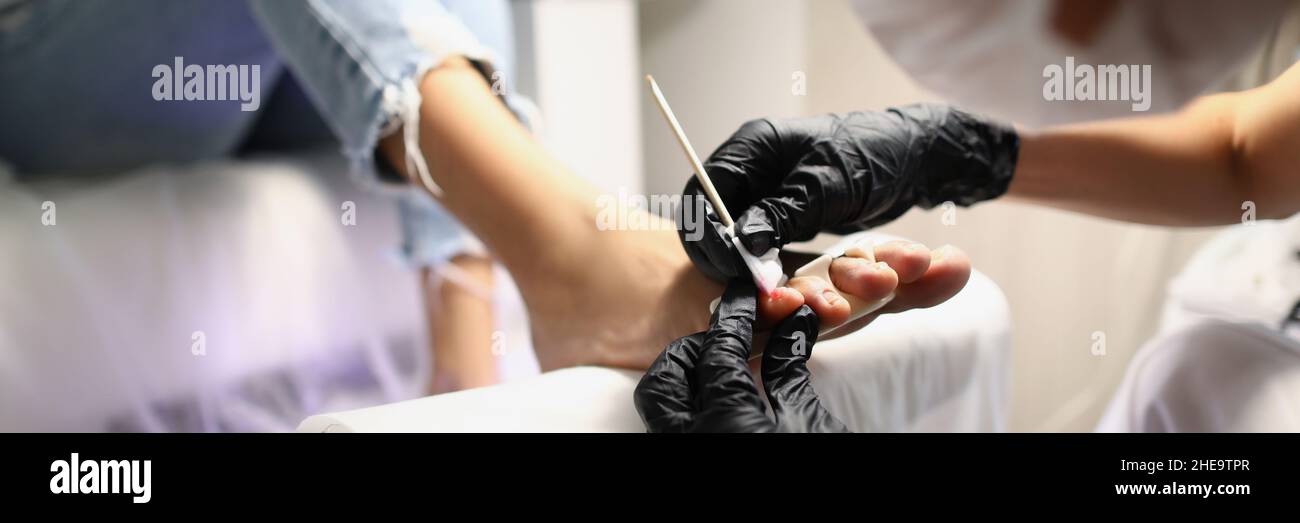 Lady cleaning persons feet Stock Photo - Alamy