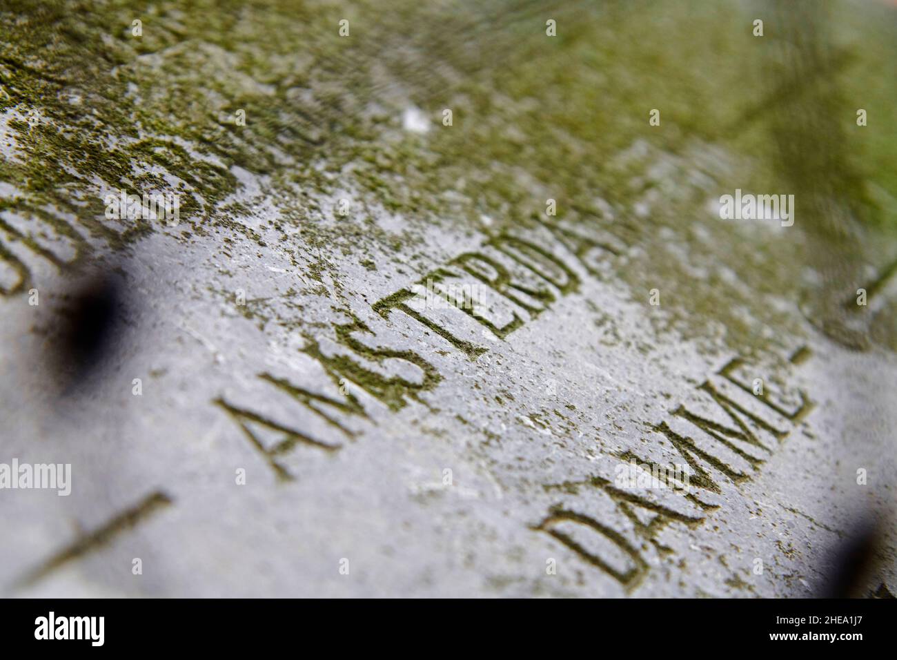Amsterdam carved in rock stone showing direction Stock Photo - Alamy
