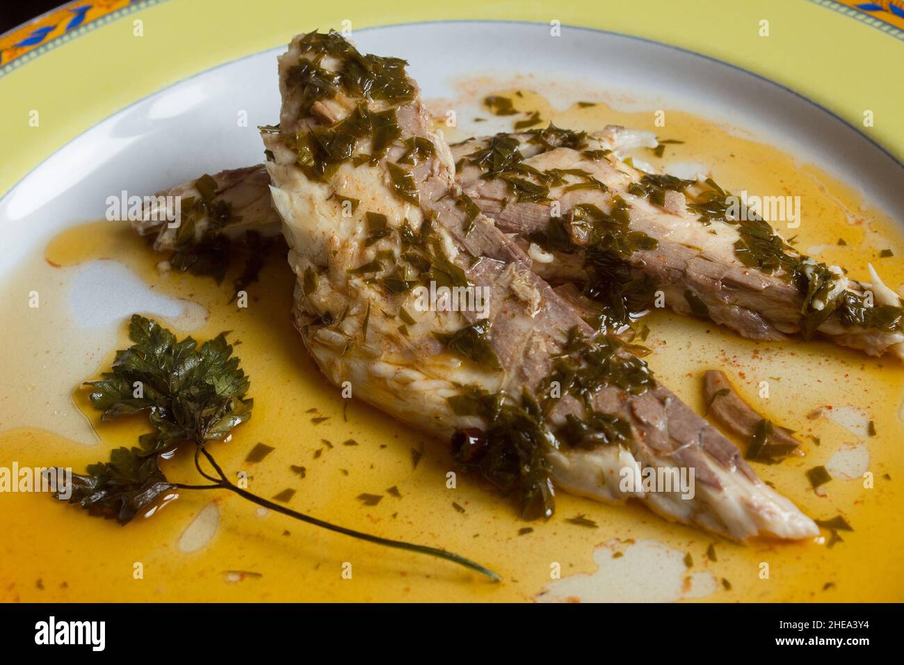 Plating of baked sea bream with a dressing of garlic sauce, vinegar ...
