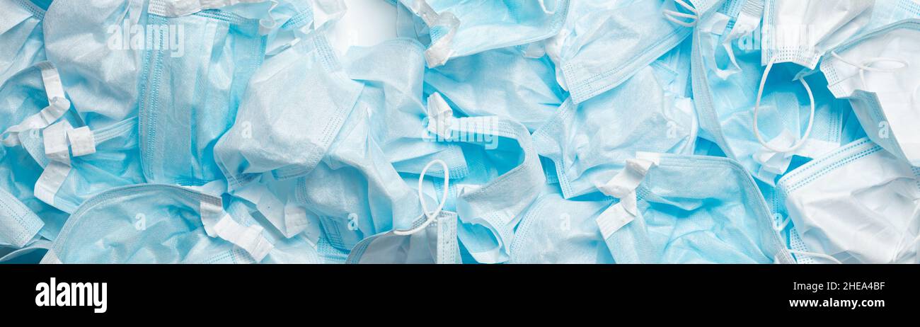 Used medical masks as background. Waste medical masks. The problem of ...