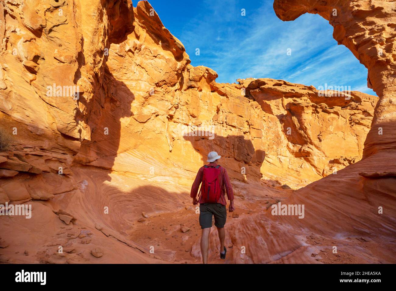 Hiker inside a stone arch in the Nevada desert near Las Vegas, Nevada ...