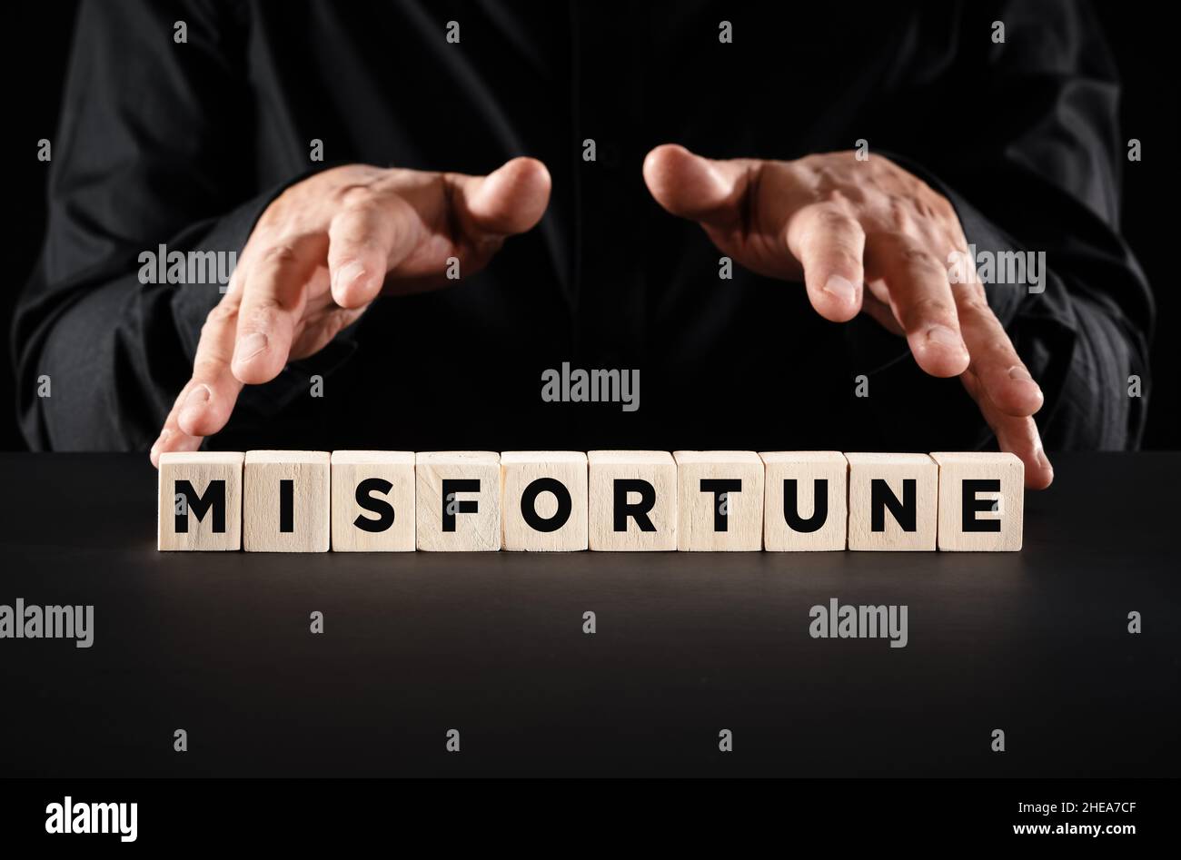 Male hands over the wooden blocks with the word misfortune. Insurance ...