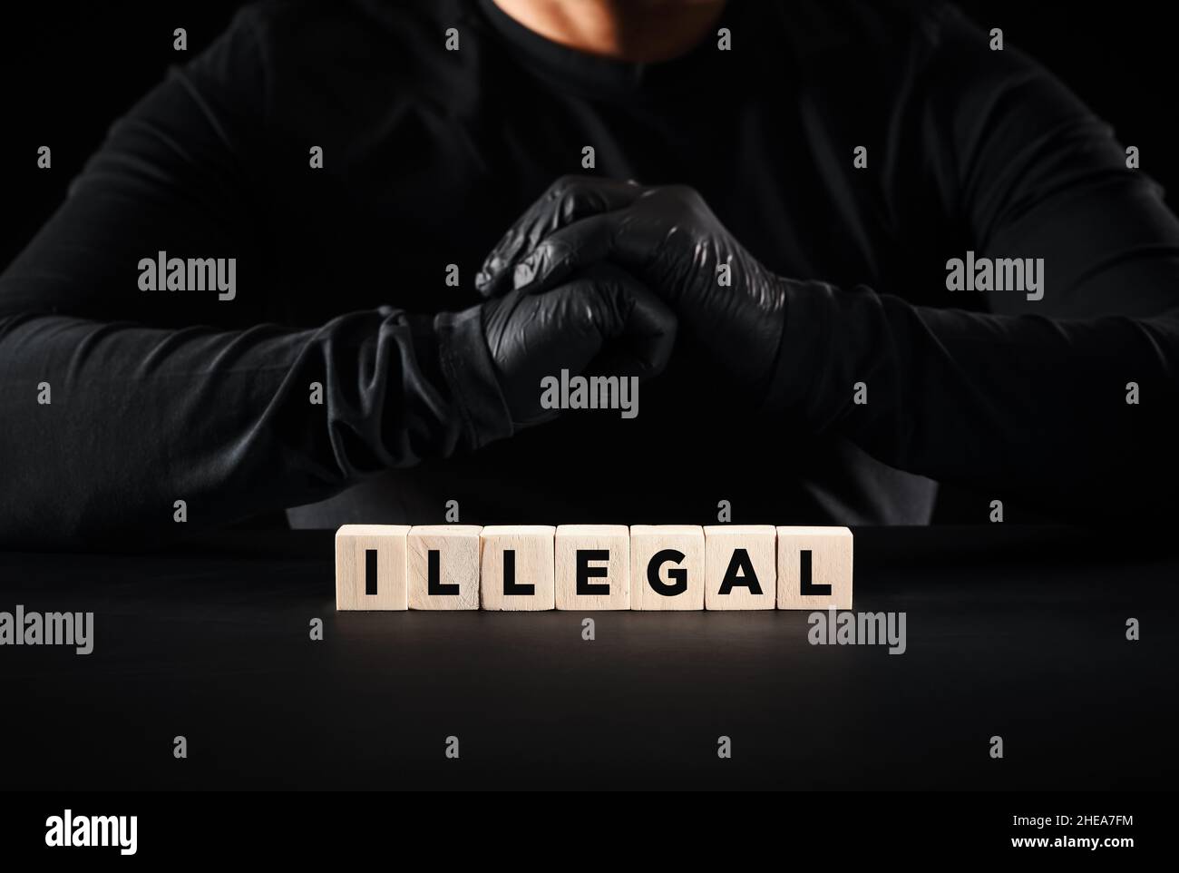 Illegal and unlawful concept. The word illegal on wooden blocks with a ...