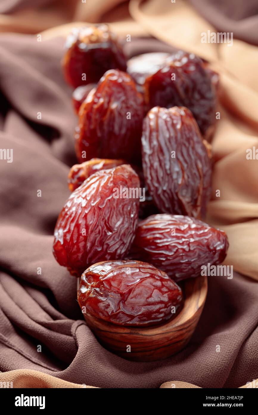 Juicy dates on the table with beige and brown satin Stock Photo - Alamy