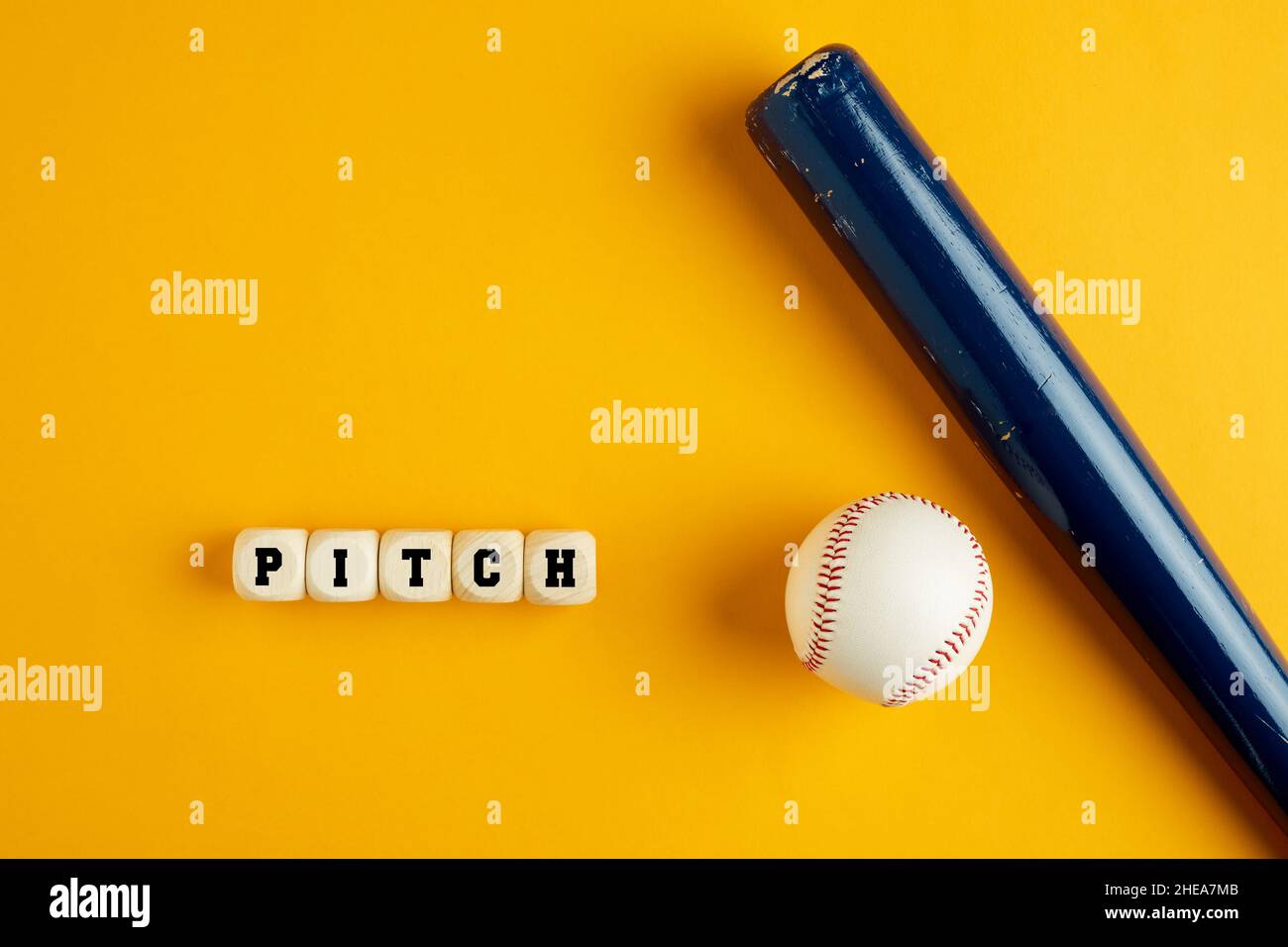 Wooden baseball bat and a ball on yellow background with the word pitch ...