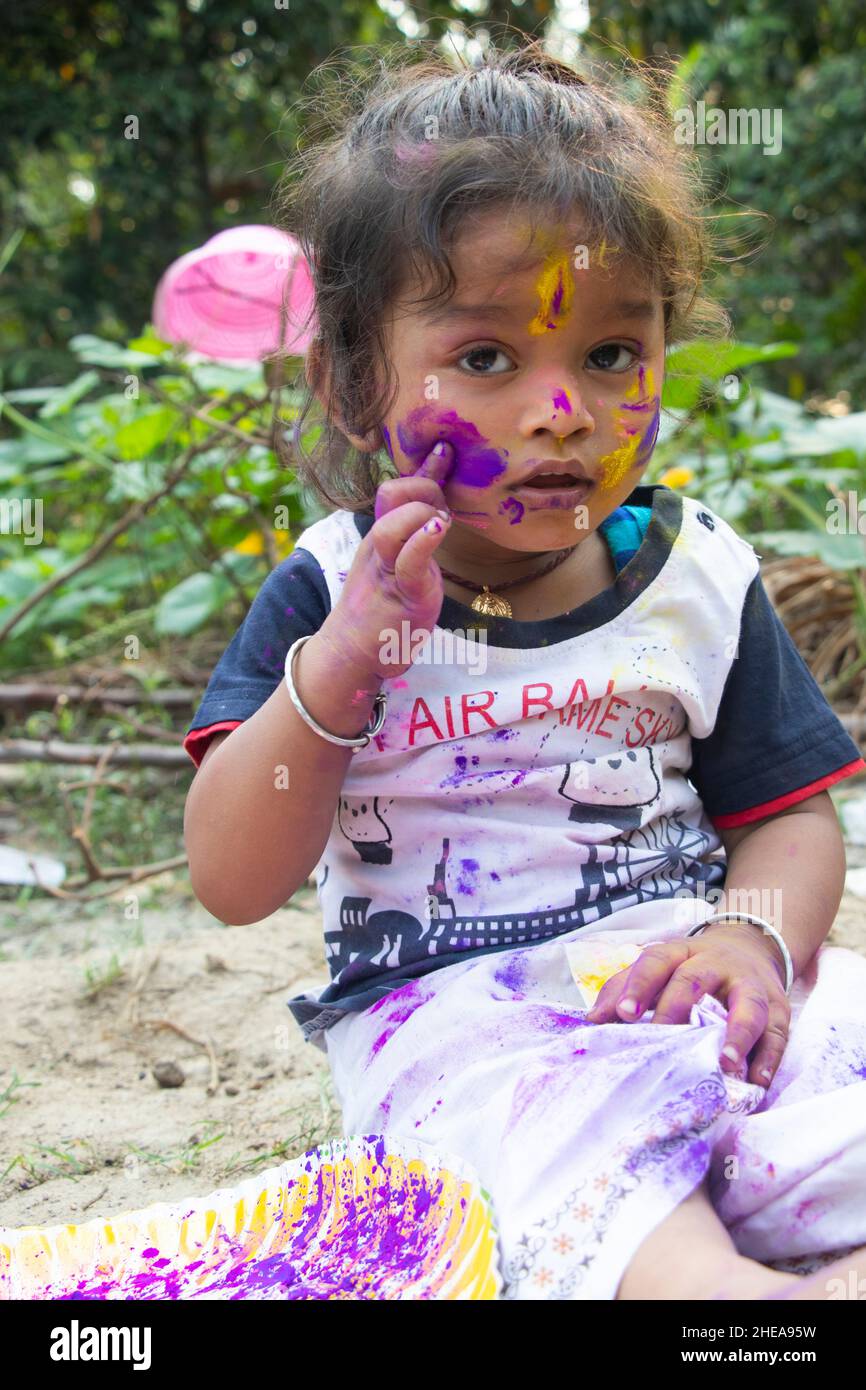 Boy enjoying festival of holi with colours looking at camera Stock ...