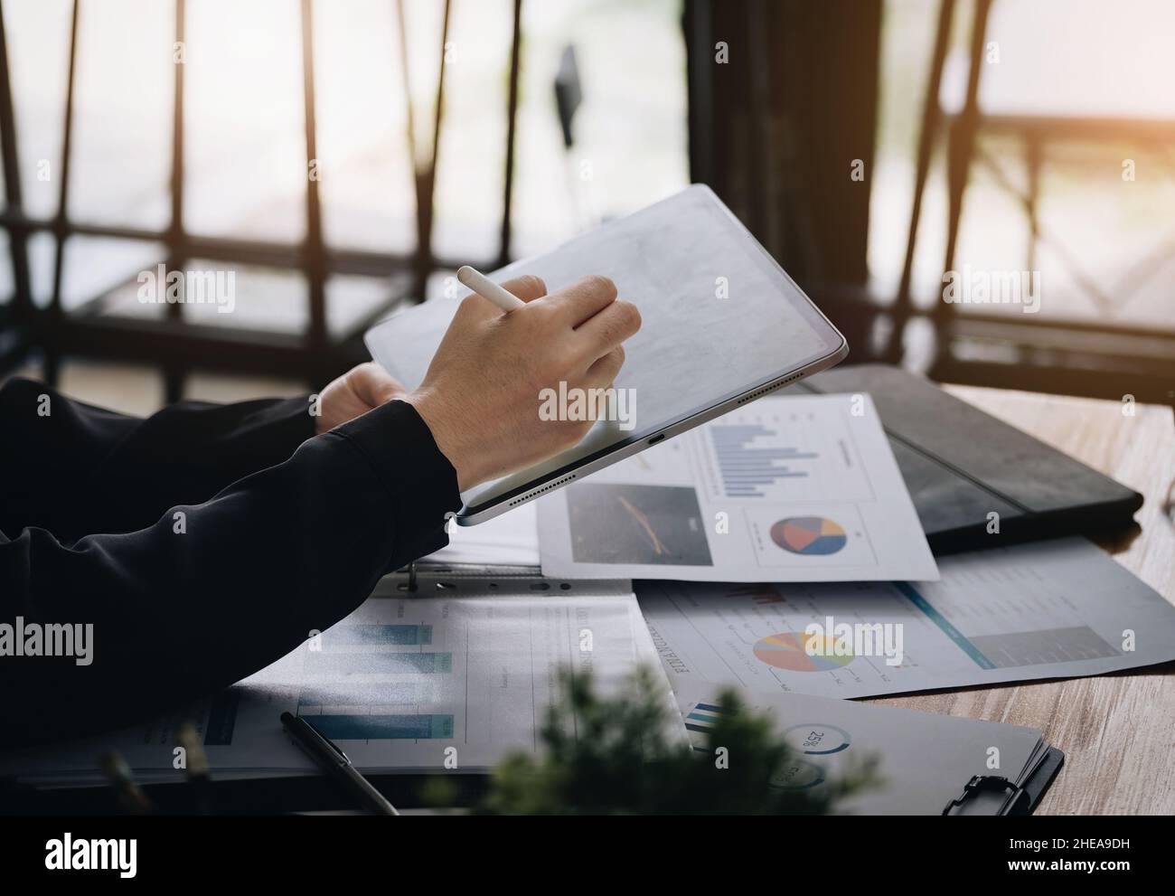 Electronic work concept, female employee is using tablet and ducument ...