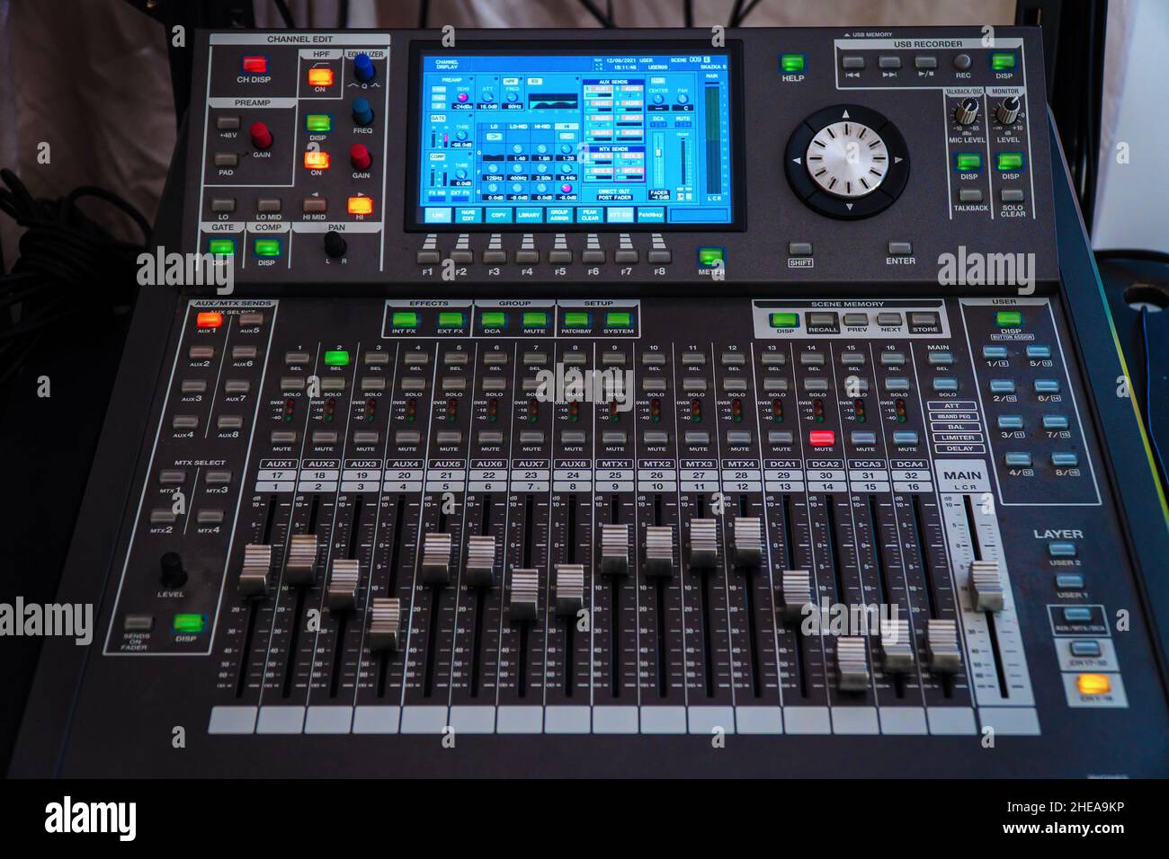 Modern digital mixing console with faders, control buttons and touch ...