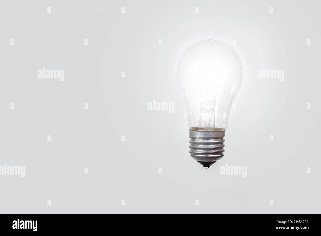 A glowing light bulb on a gray background, a place for text Stock Photo ...