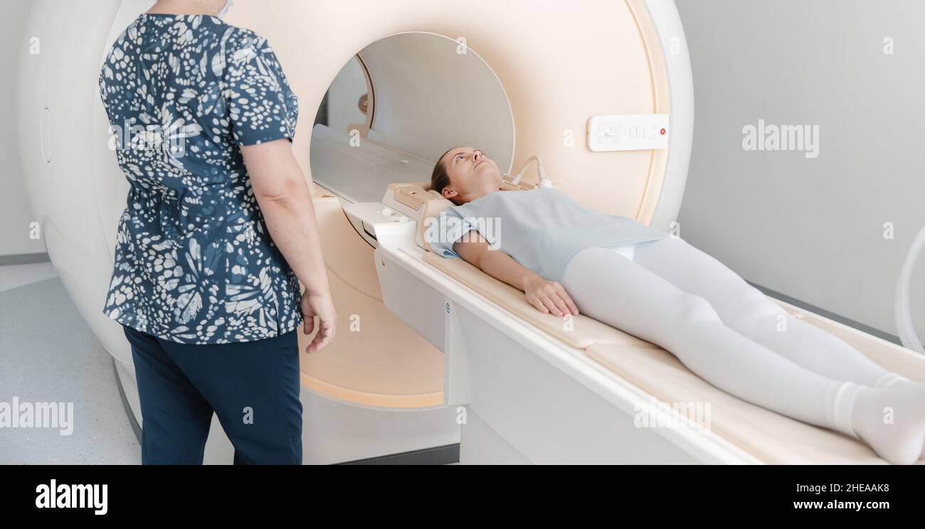 Doctor or nurse and patient with tomography CT or MRI Scan in hospital ...