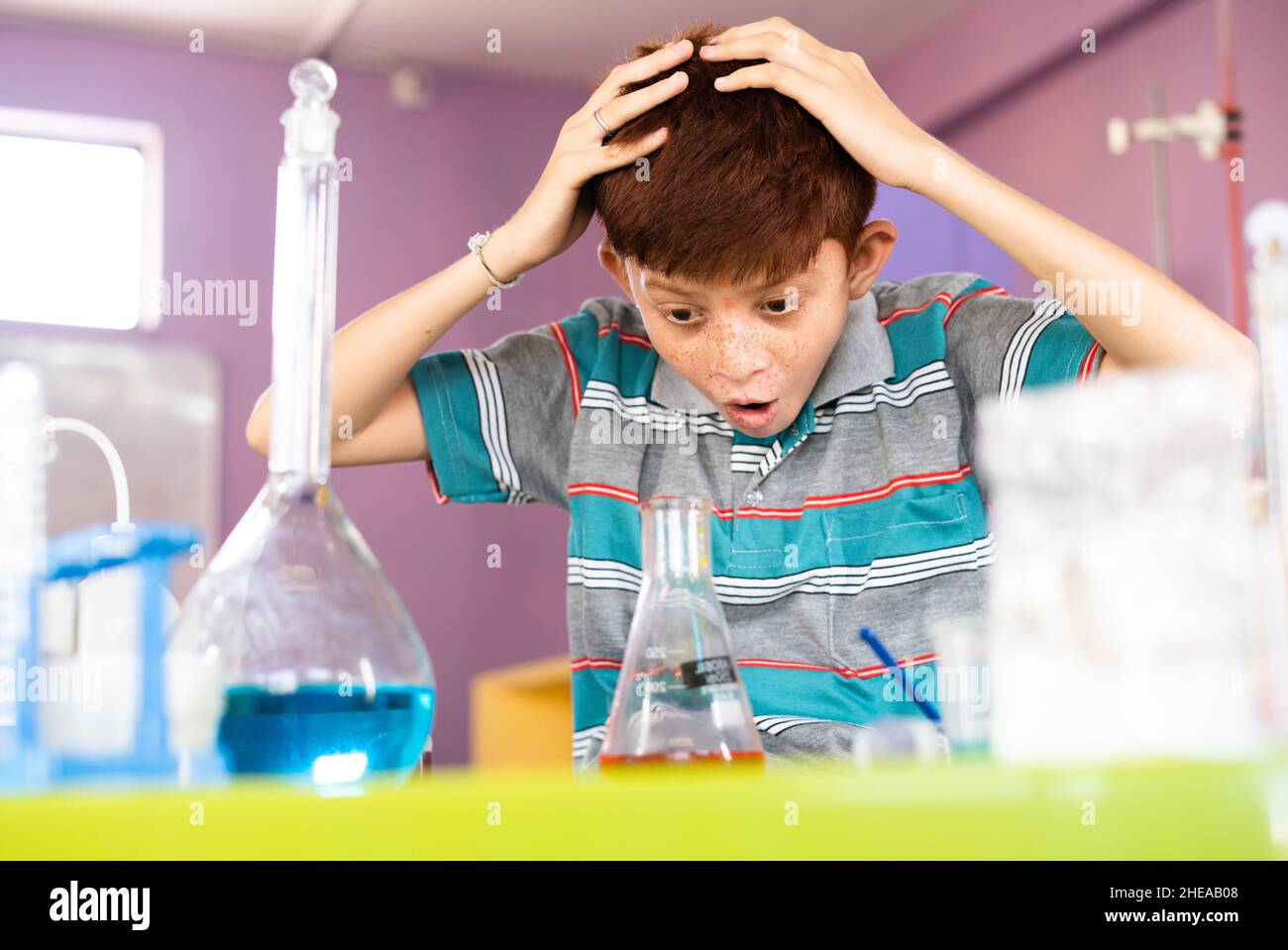 Shocked are surprised young Caucasian kid while doing science ...