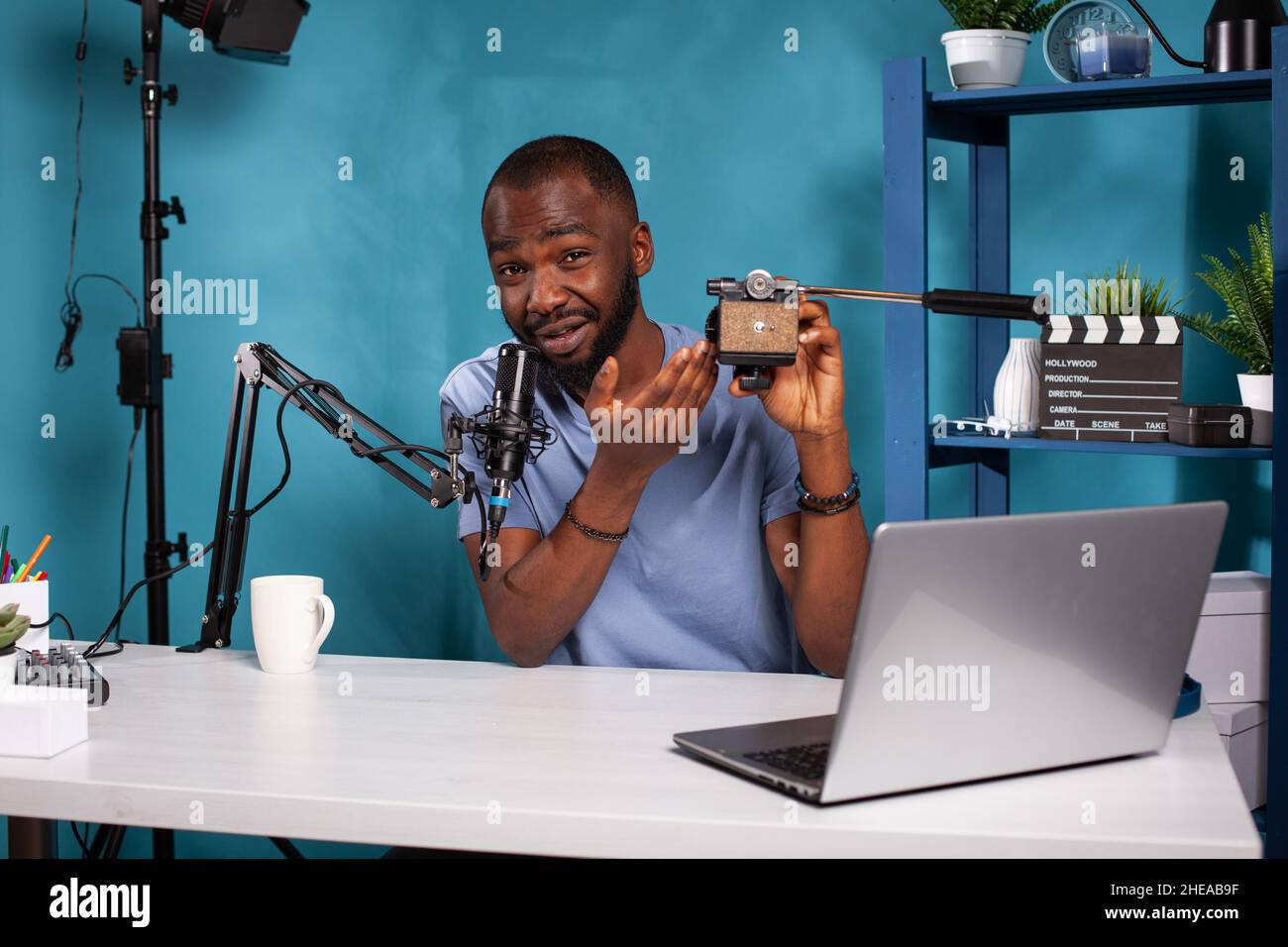 Vlogger explaining features of videography stabilization device with ...