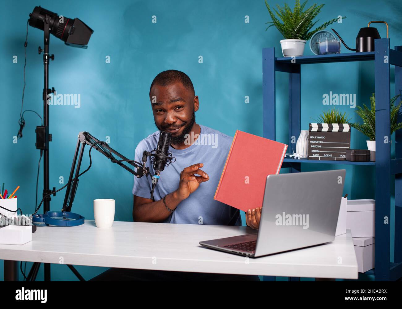 Famous vlogger reviewing excellent book talking to audience using ...